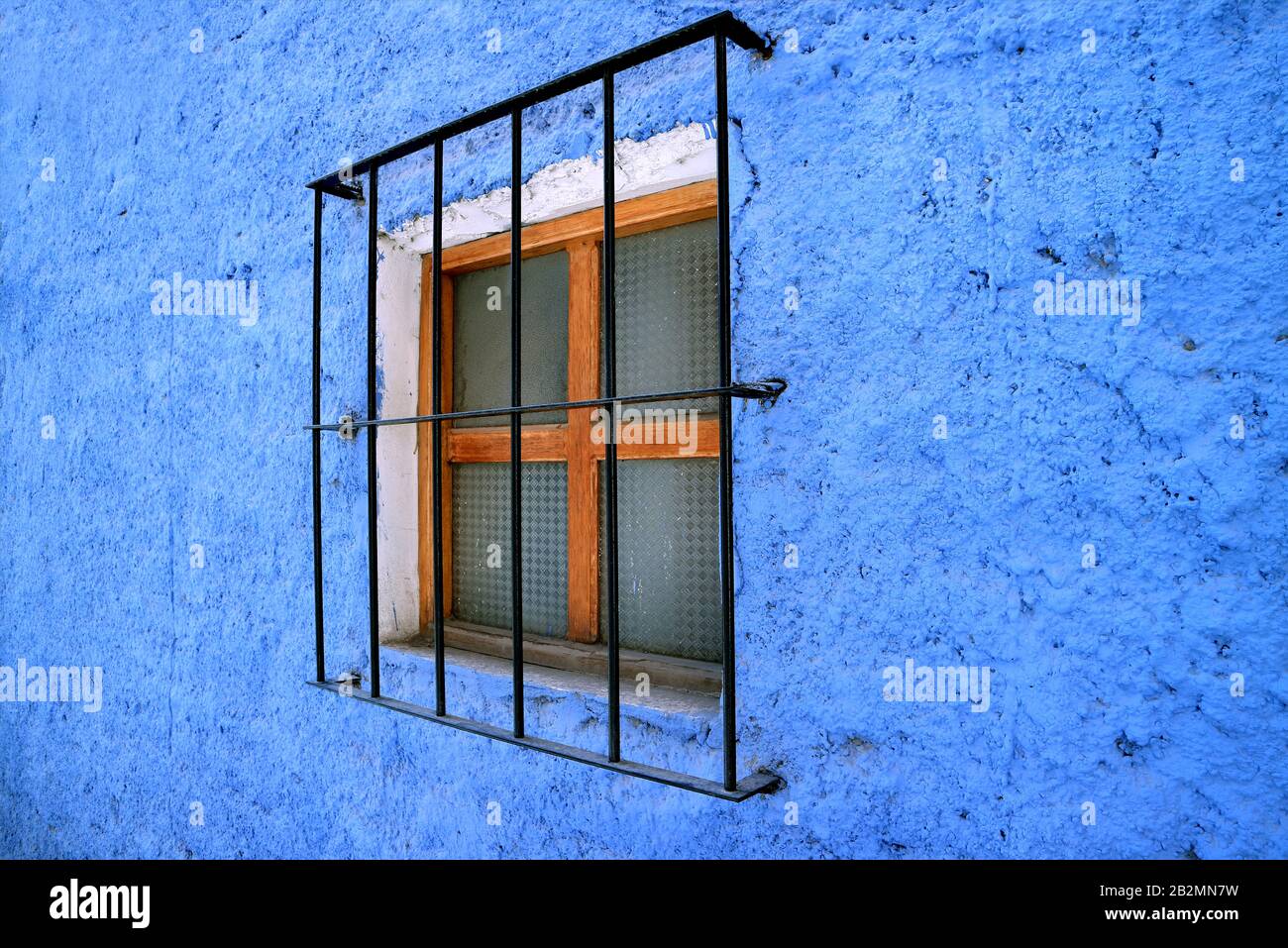 Wooden Frame Window on Vivid Blue Colored Stone Wall Stock Photo - Alamy