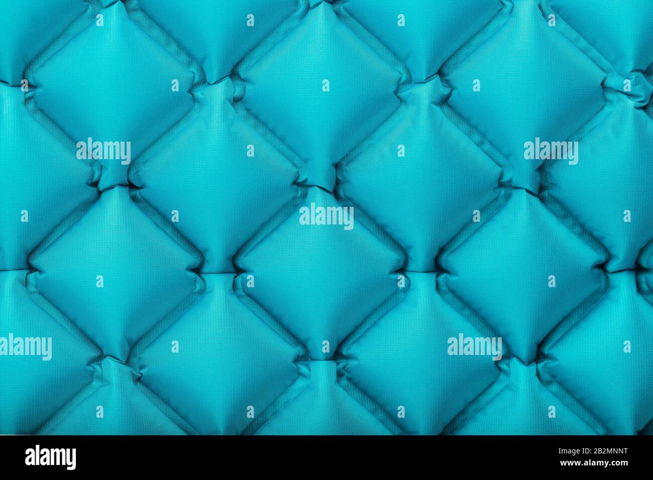 Texture of a blue inflatable tourist rug, repeating sections and ...