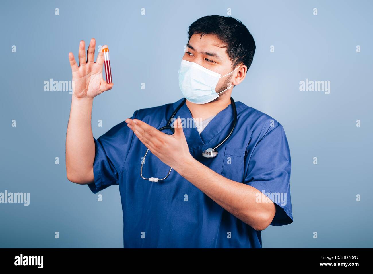 The doctor holds in his hands a test tube with blood Stock Photo - Alamy