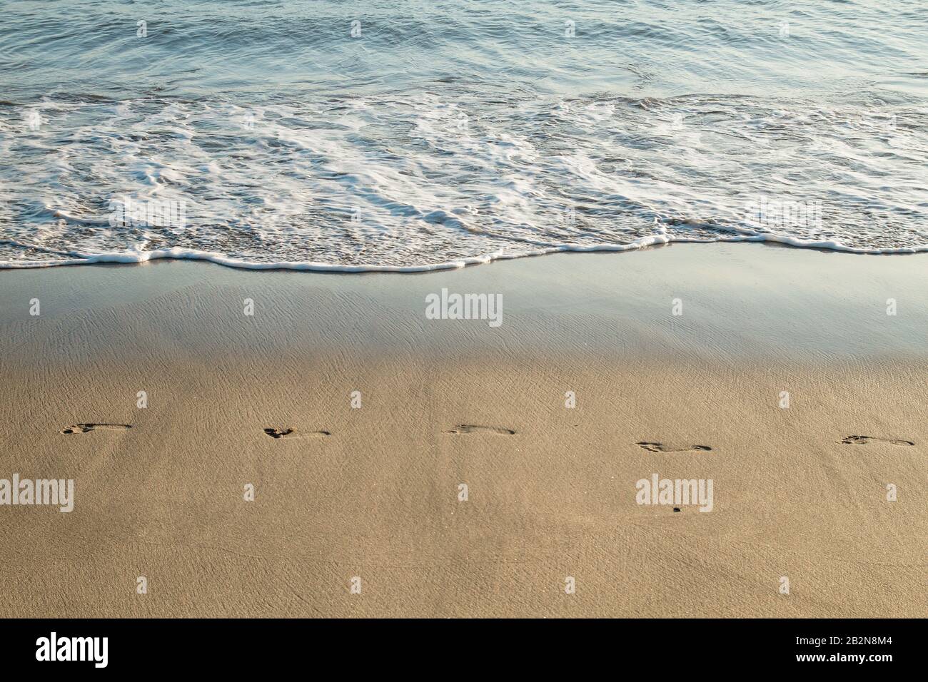 Footprints on golden sandy beach hi-res stock photography and images ...