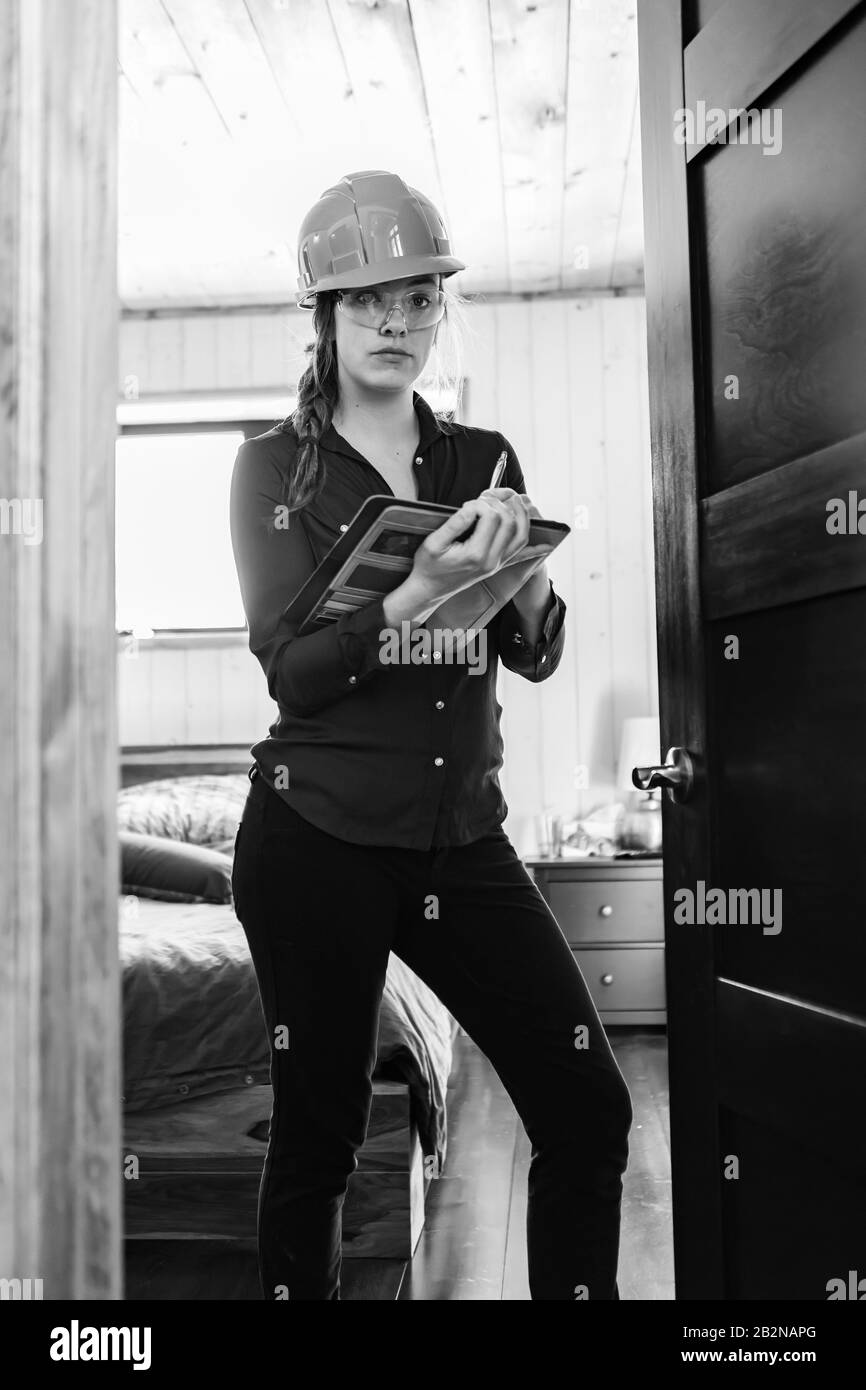 Smiling woman holding clipboard Black and White Stock Photos & Images ...