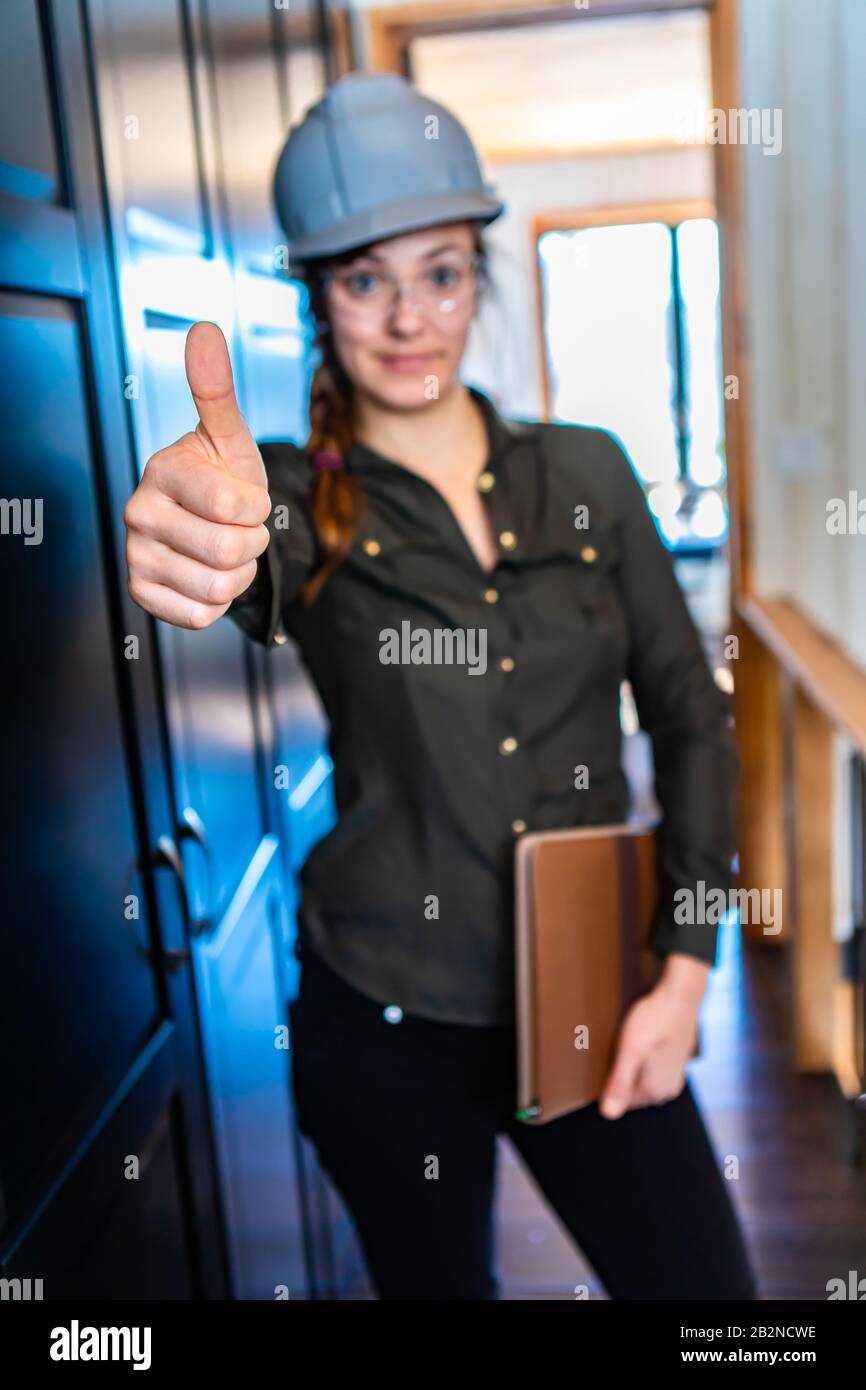 selective focus on female inspector finger giving thumb up as she ...