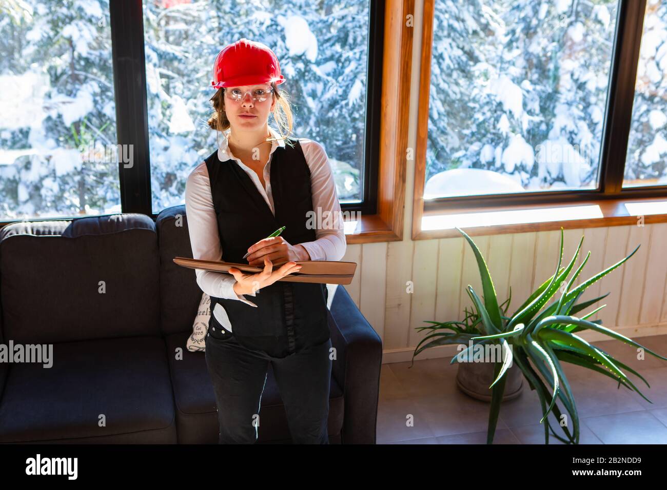 worker woman at work concept. female home inspector wearing a red hard ...