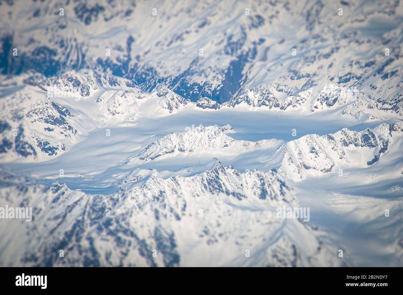 Tilt shift effect of glacier of the Alps seen from the plane Stock ...