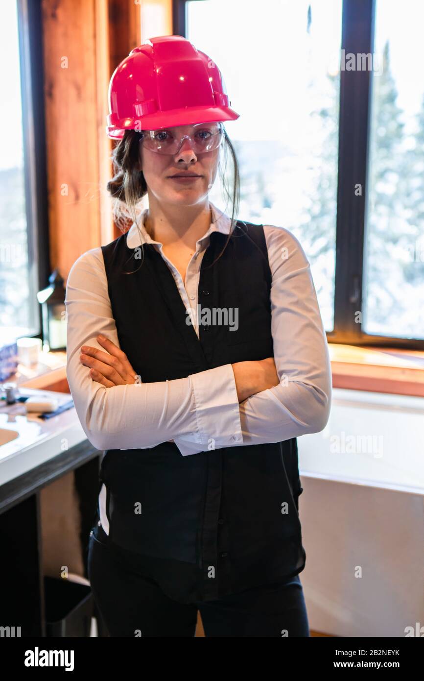 young female construction inspector standing with crossed arms pose ...
