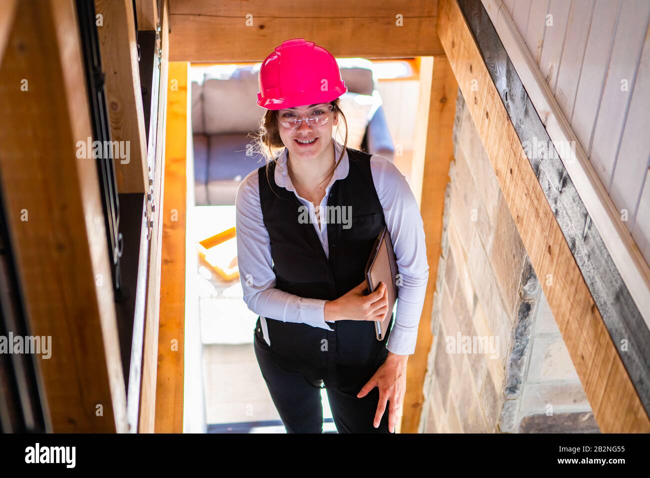 young architect woman smiling on the stairs. Female Civil engineer ...