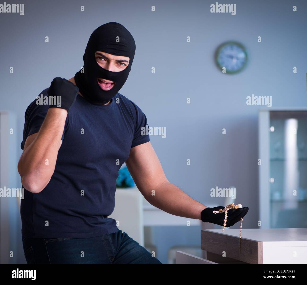 The robber wearing balaclava stealing valuable things Stock Photo - Alamy