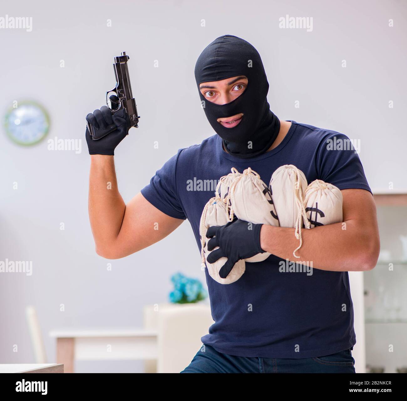 The robber wearing balaclava stealing valuable things Stock Photo - Alamy
