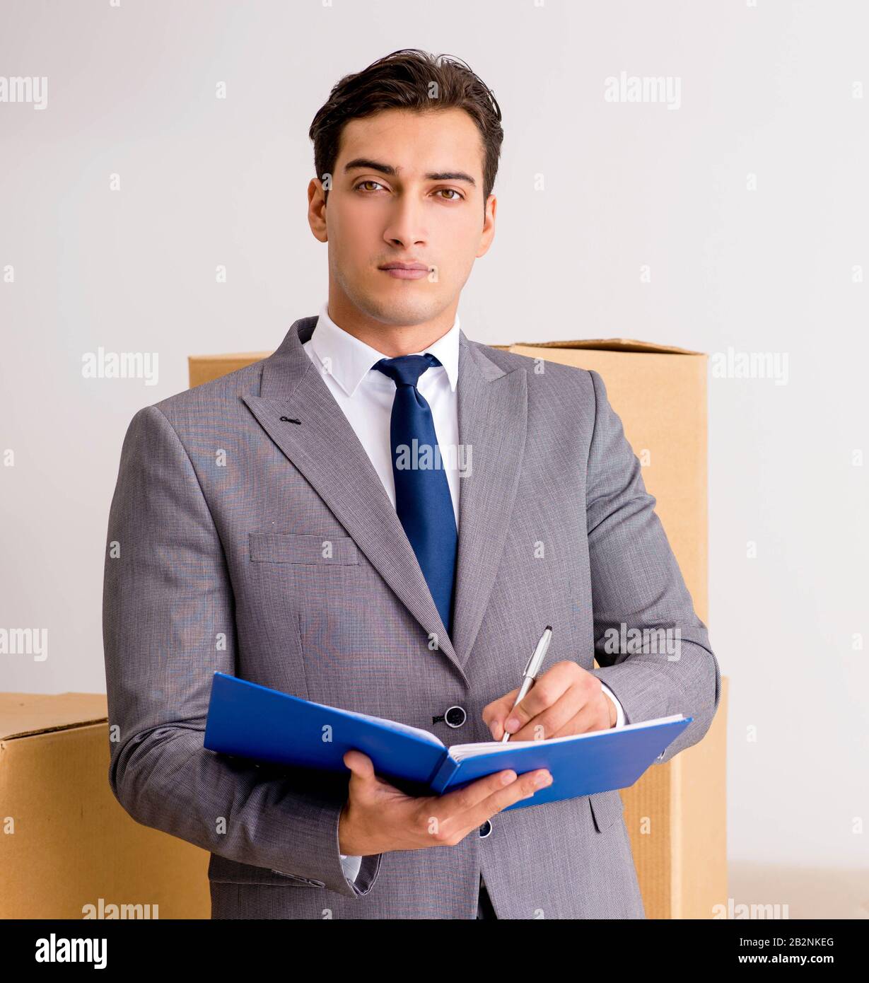 The man signing for the delivery of boxes Stock Photo - Alamy