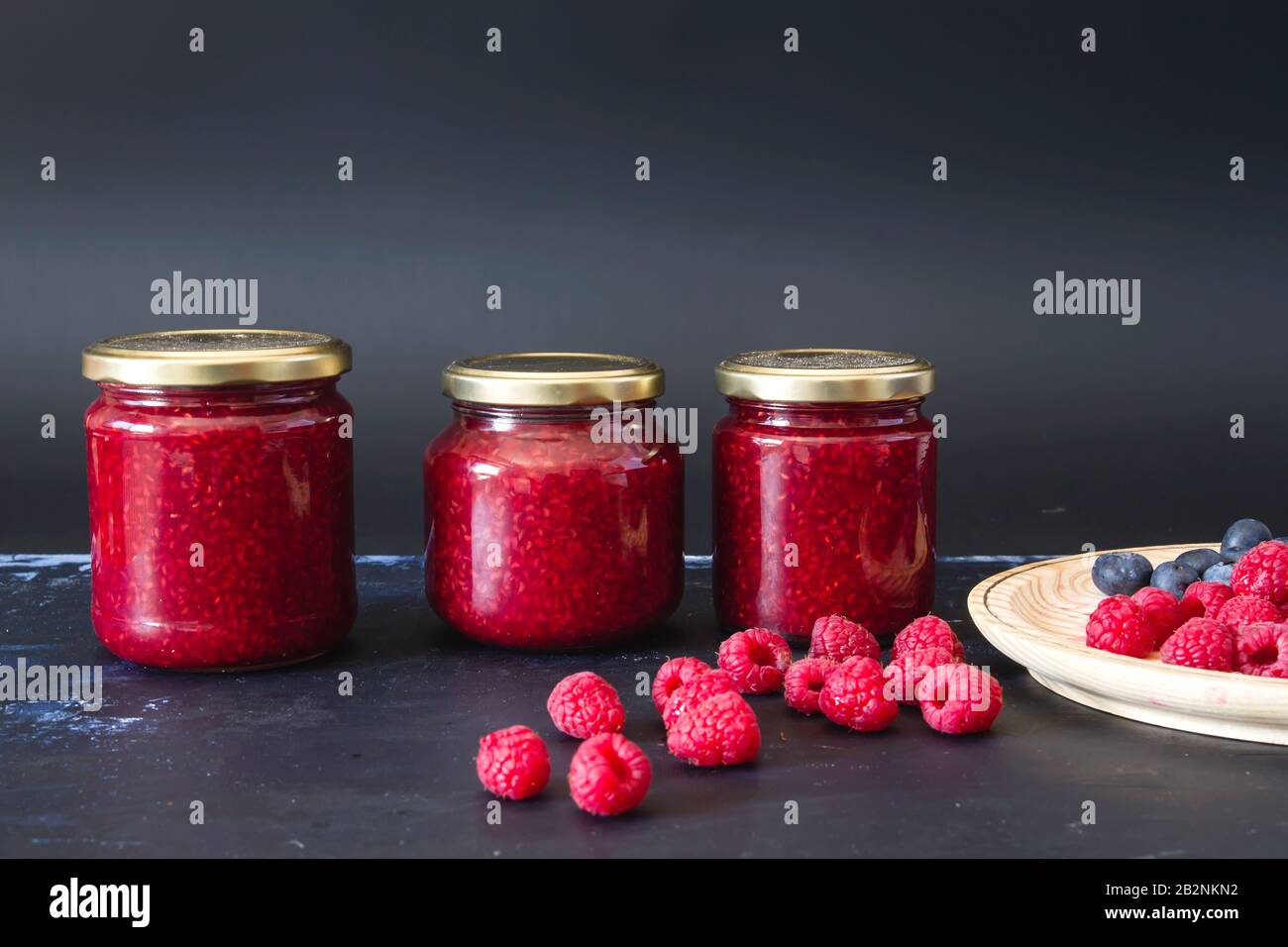 Homemade red fruits jam, dark backdrop Stock Photo - Alamy