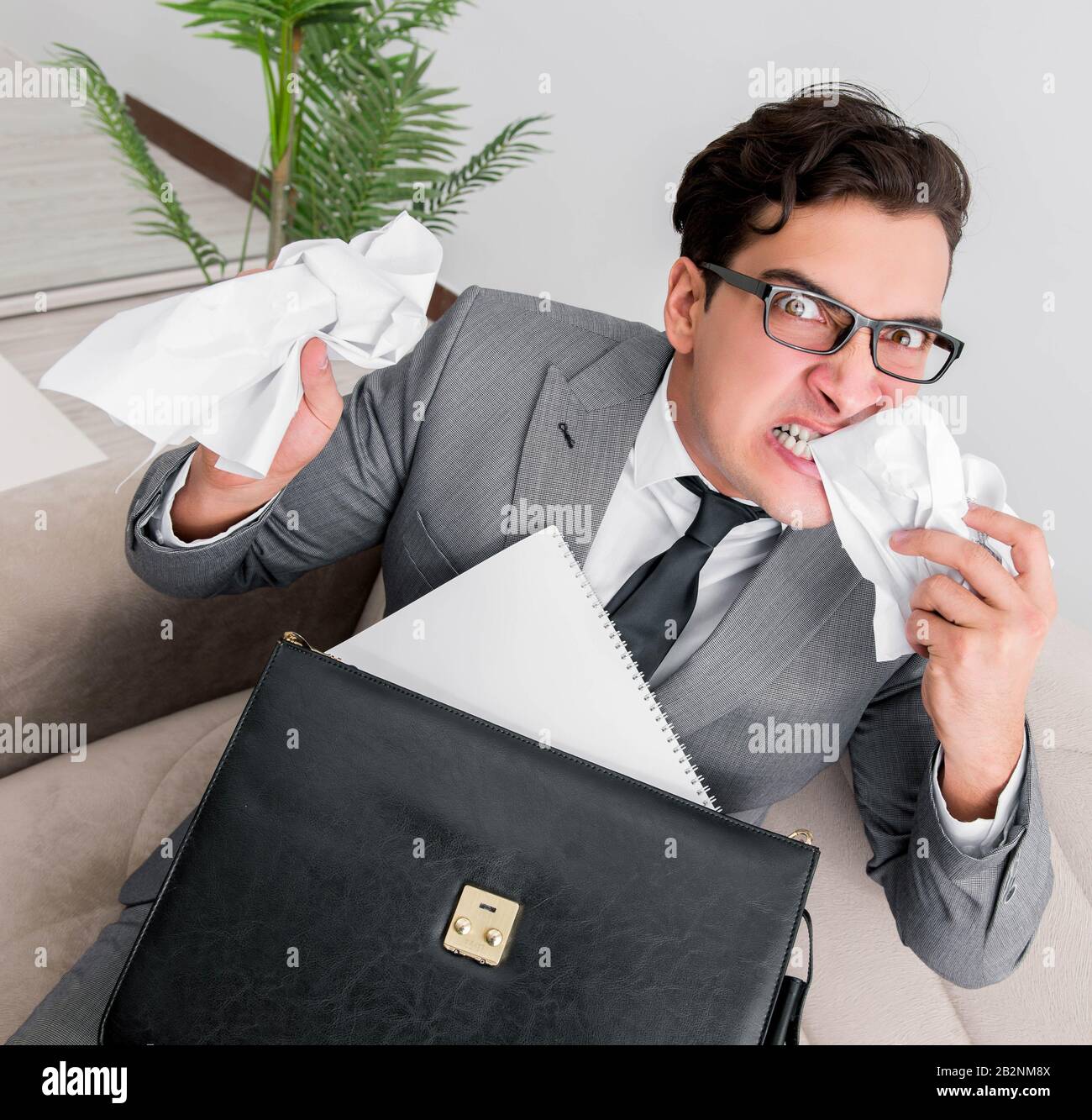 The angry businessman with crumbled paper Stock Photo - Alamy