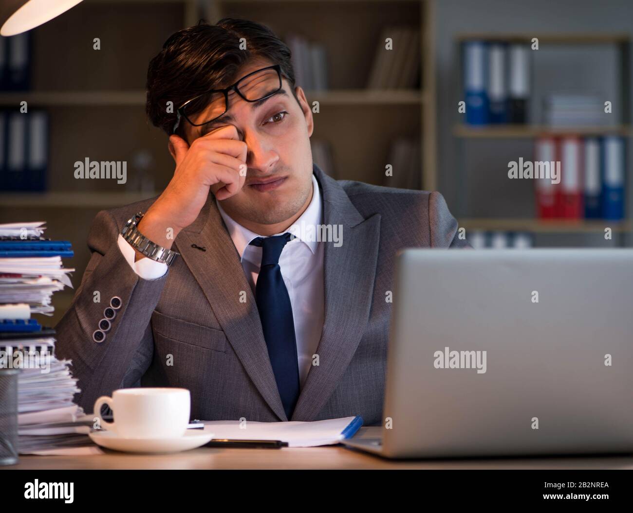 The businessman staying in the office for long hours Stock Photo - Alamy