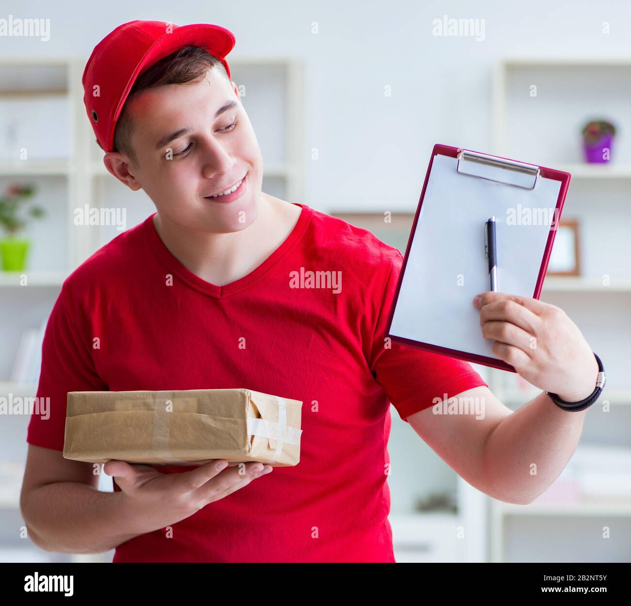The post man delivering a parcel package Stock Photo - Alamy