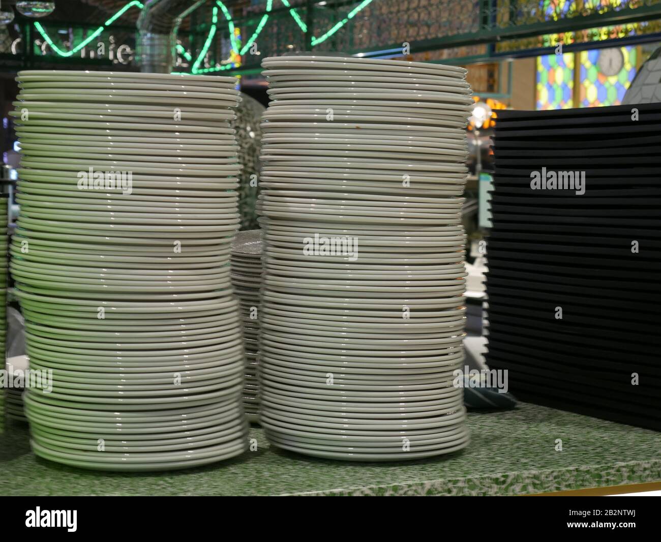 Two stacks of dinner plates piled high on a counter Stock Photo - Alamy