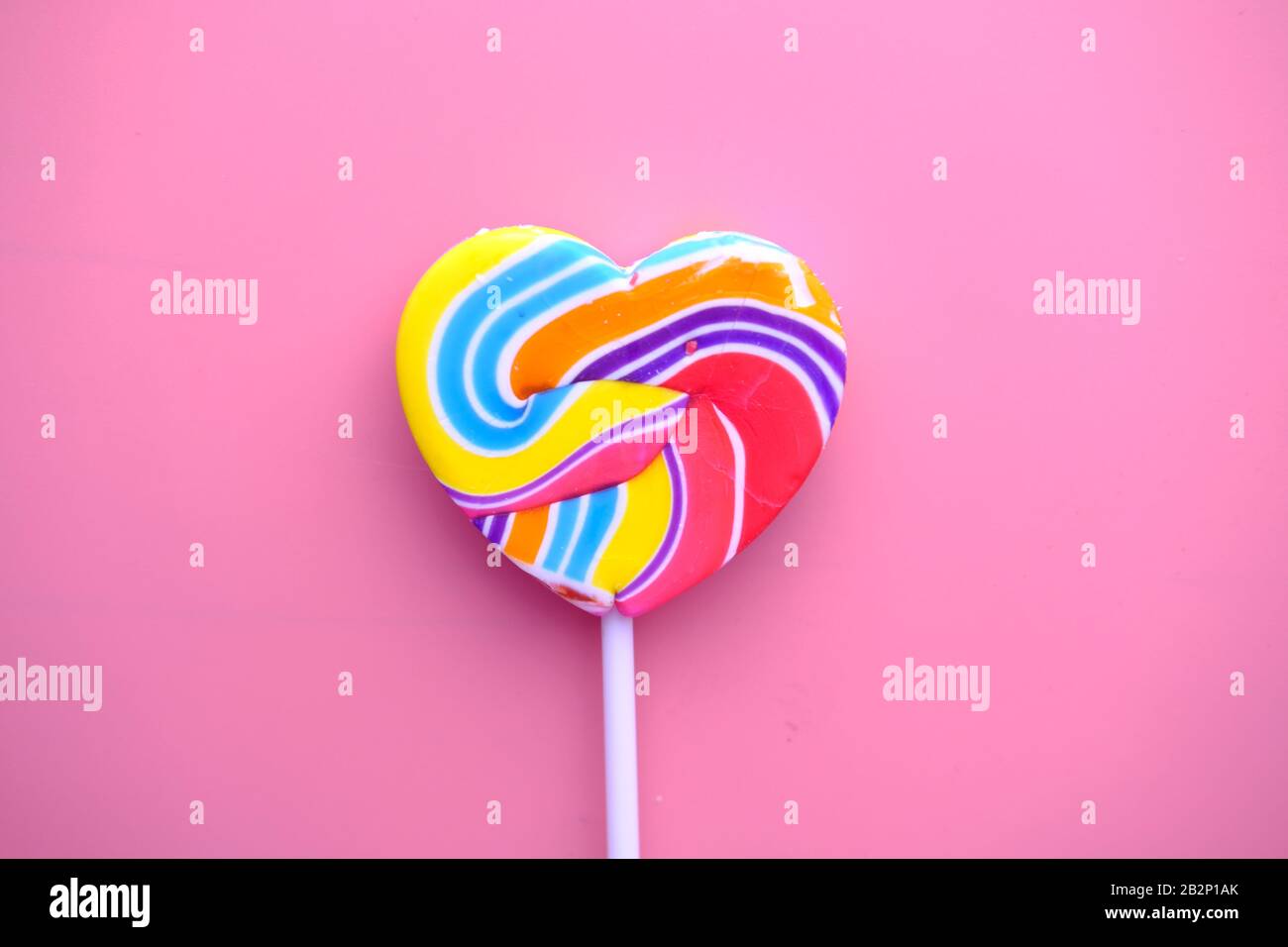 heart shape candy on pink color background Stock Photo - Alamy