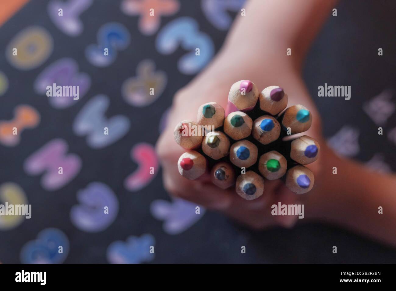 top view of child boy hand holding color pencils Stock Photo - Alamy