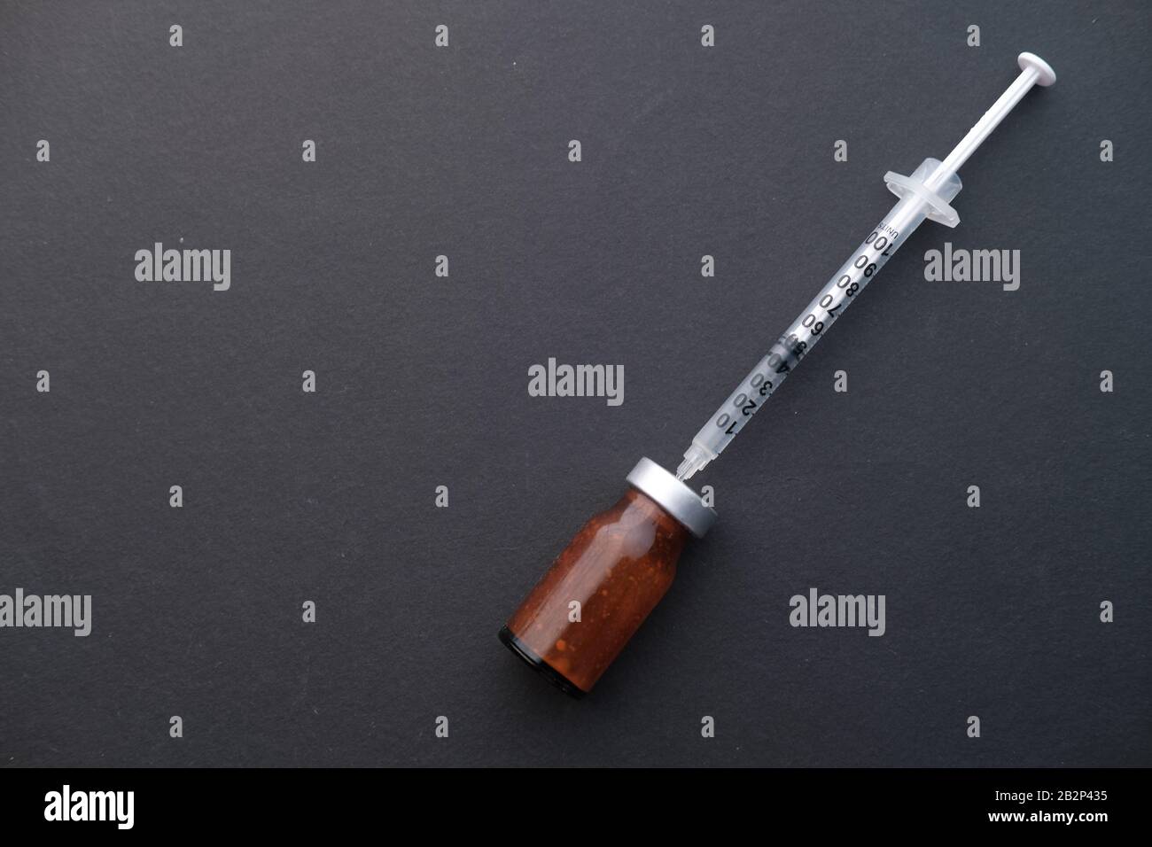 top view of syringe on black background Stock Photo - Alamy