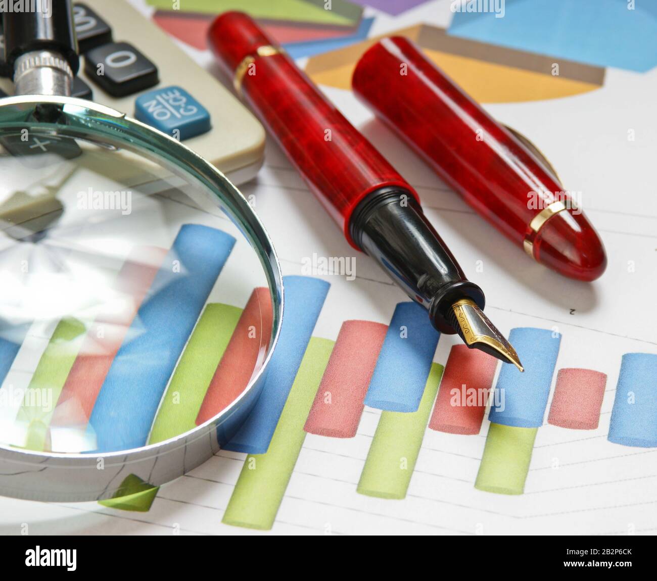 pen, magnifying glass and the working paper with a diagram Stock Photo ...