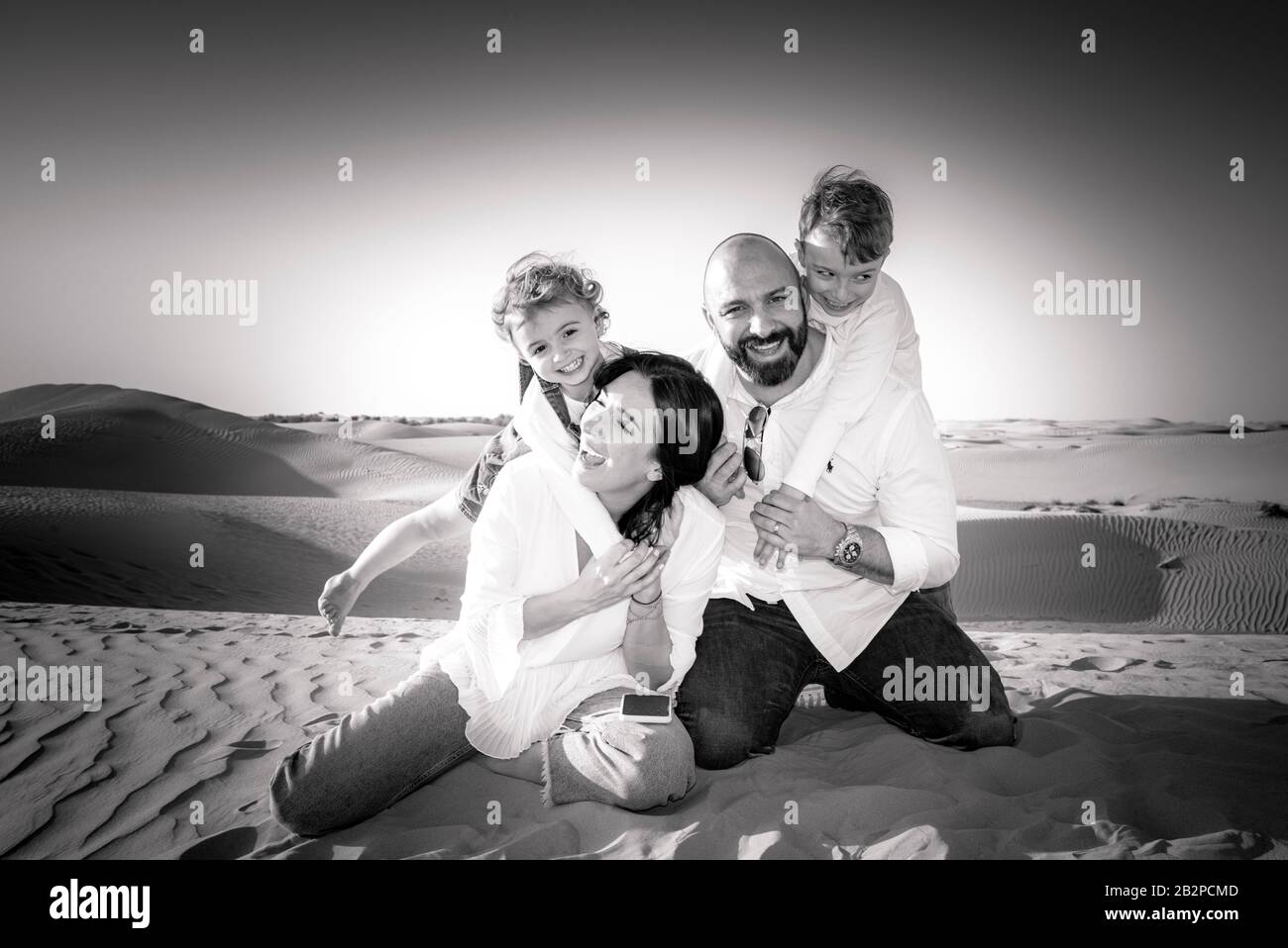 family group portrait,having fun together,in a desert setting with sand ...