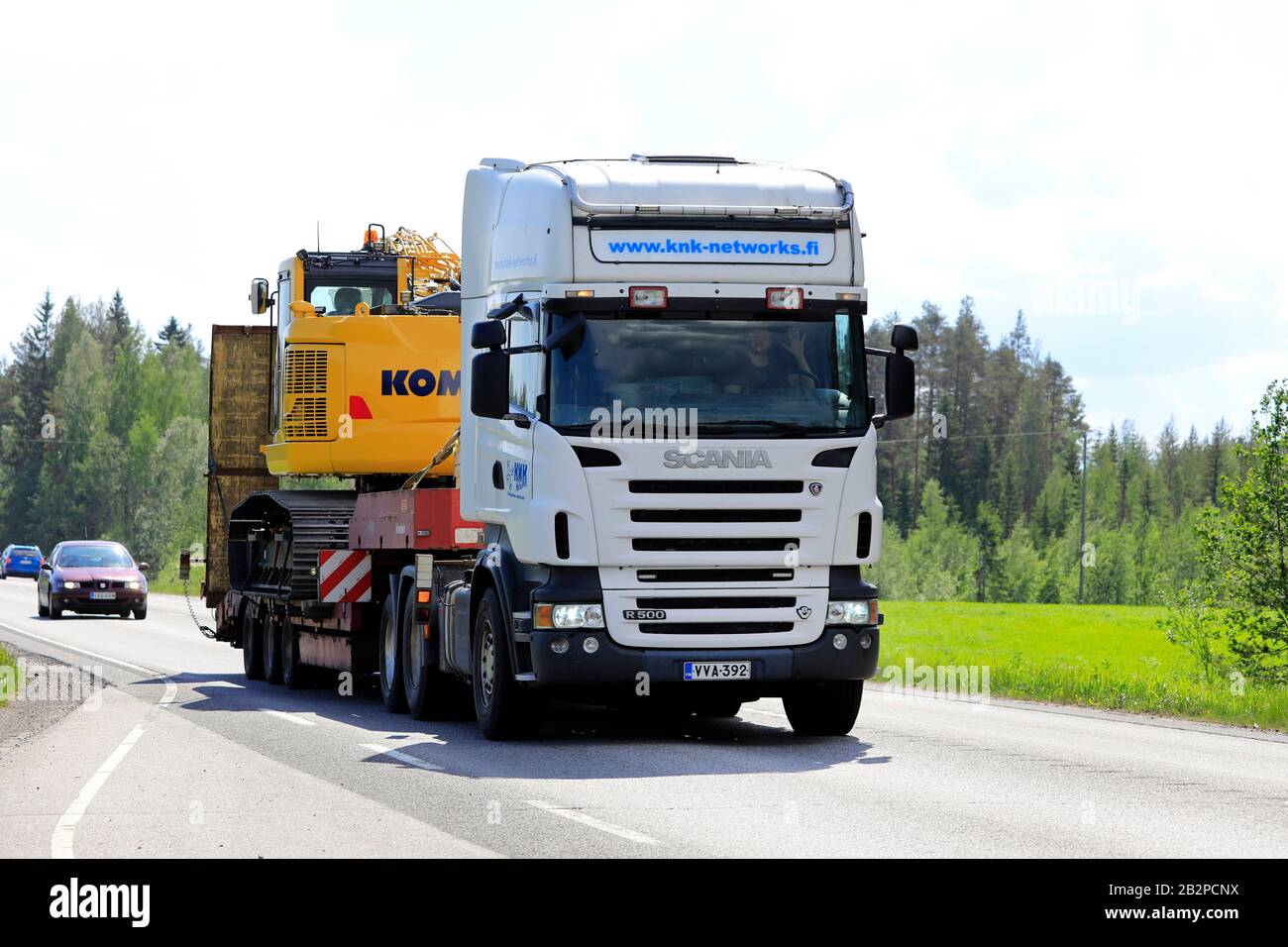 White Scania R500 truck of KNK networks transports Komatsu excavator on ...