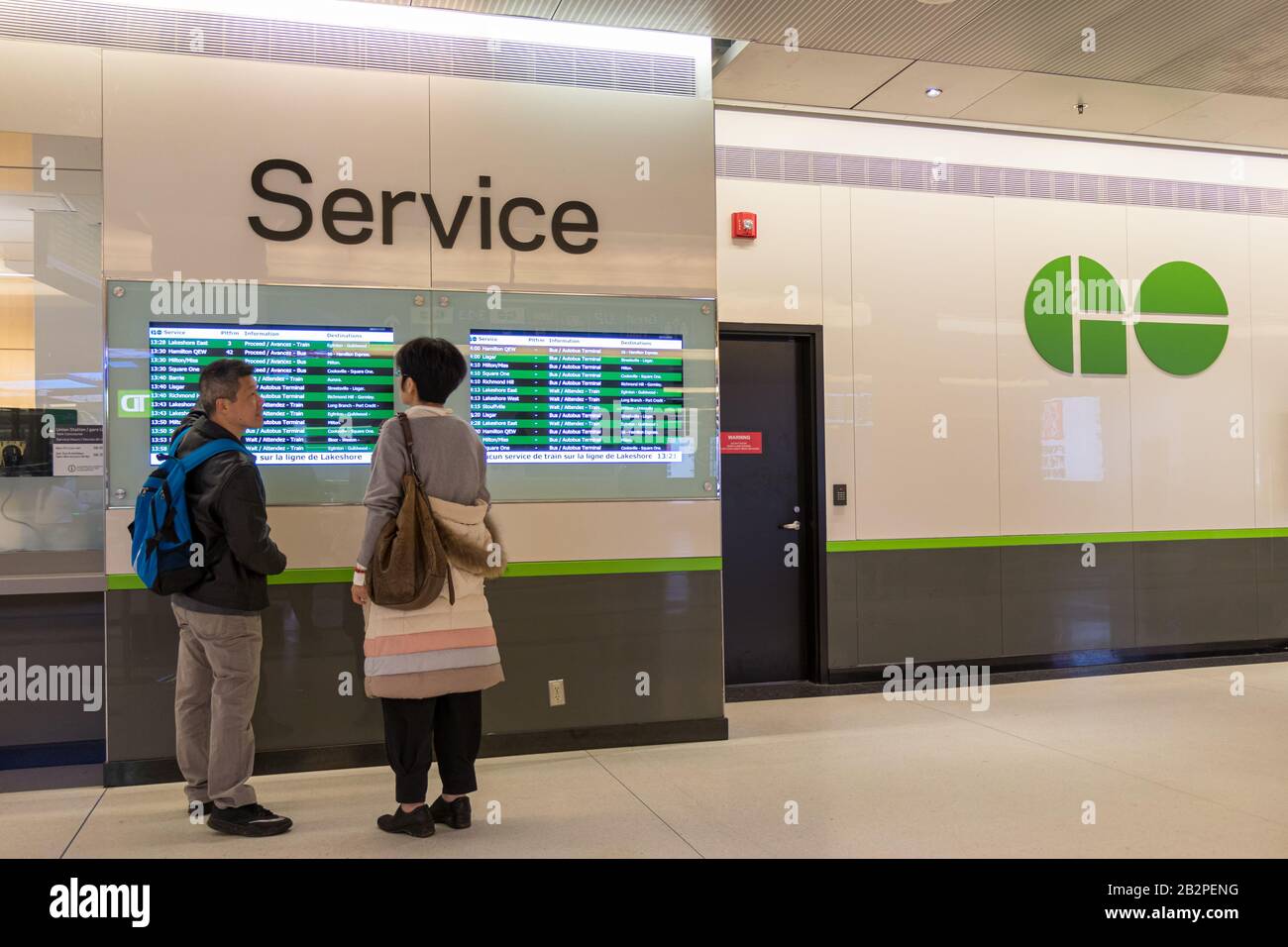 Couple looking at GO Transit schedule at a service station in Union ...