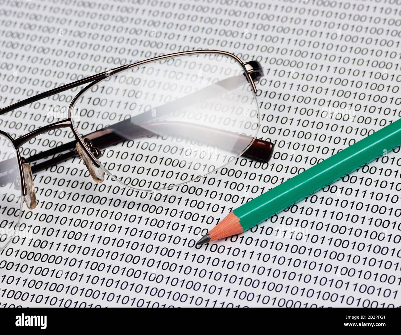 glasses and pencil on the background of a binary code Stock Photo - Alamy