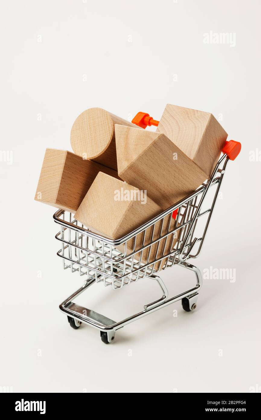 wooden blocks for the construction in shopping trolley on a white ...