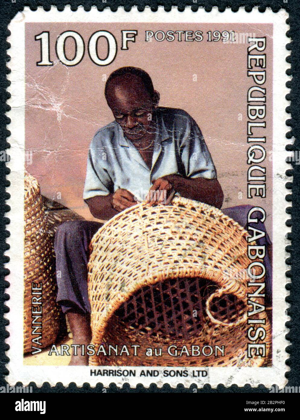 GABON - CIRCA 1991: A stamp printed in Gabon, depicted the basket maker ...