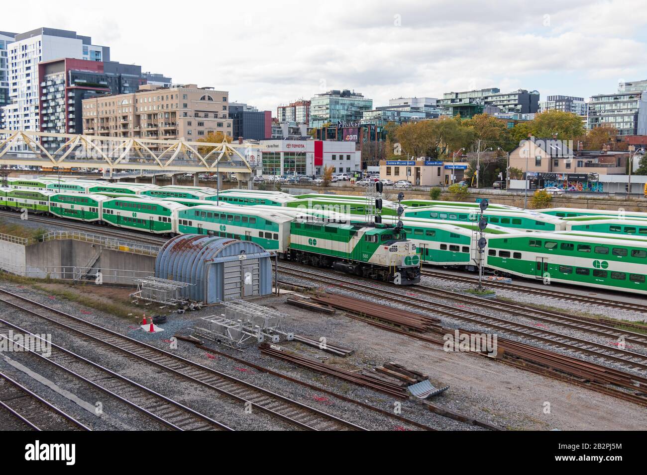 A GO Transit Train passes through a full rail depot near Union Station ...