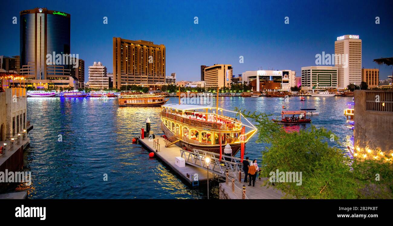 Floating dhow restaurant at Dubai Creek early evening with city ...