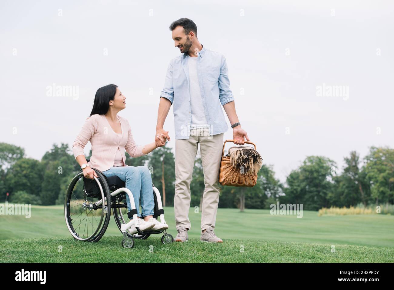 Woman in basket wheelchair hi-res stock photography and images - Alamy