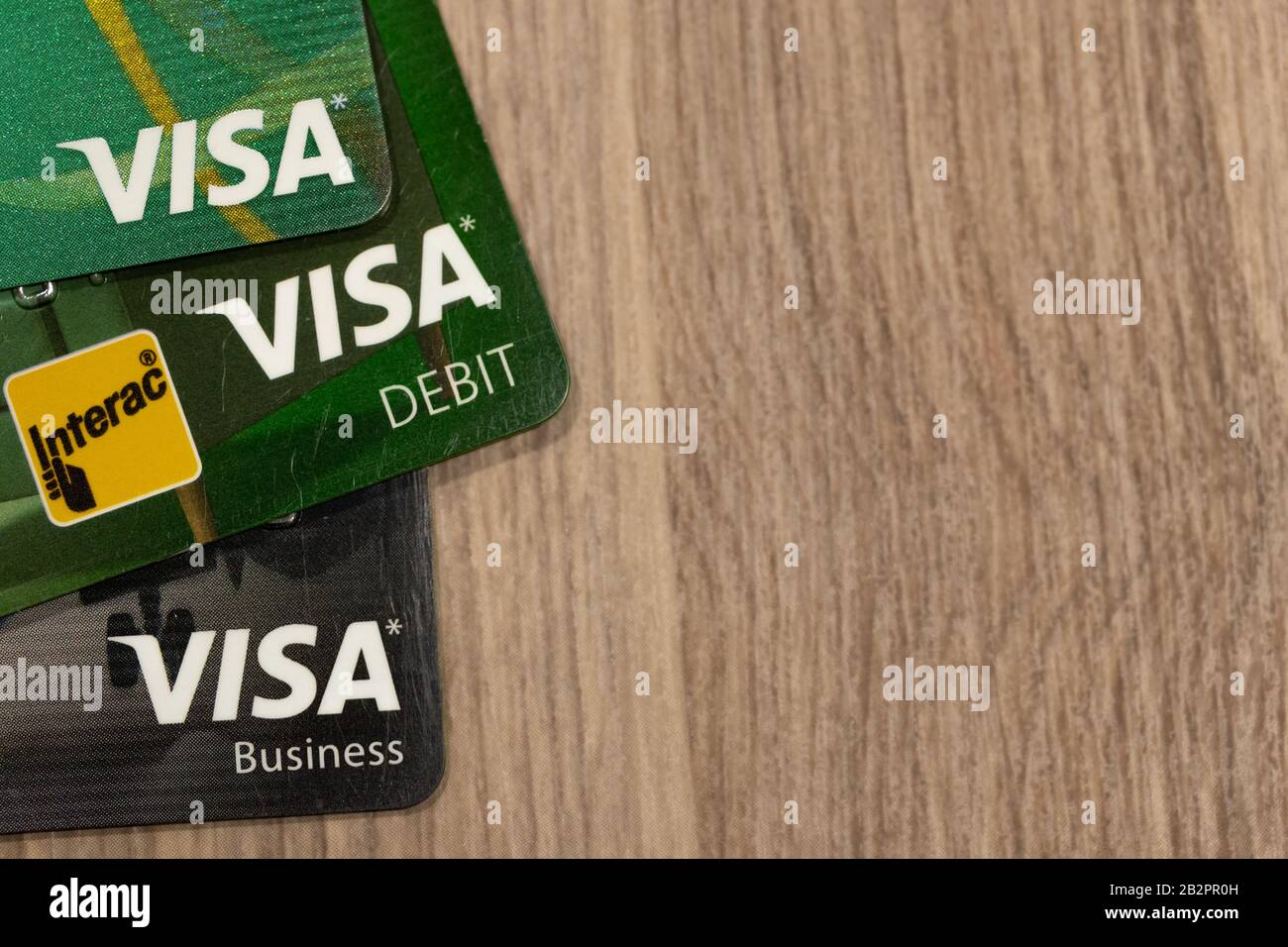 Three VISA cards - VISA, VISA Debit and VISA Business place on a desk ...
