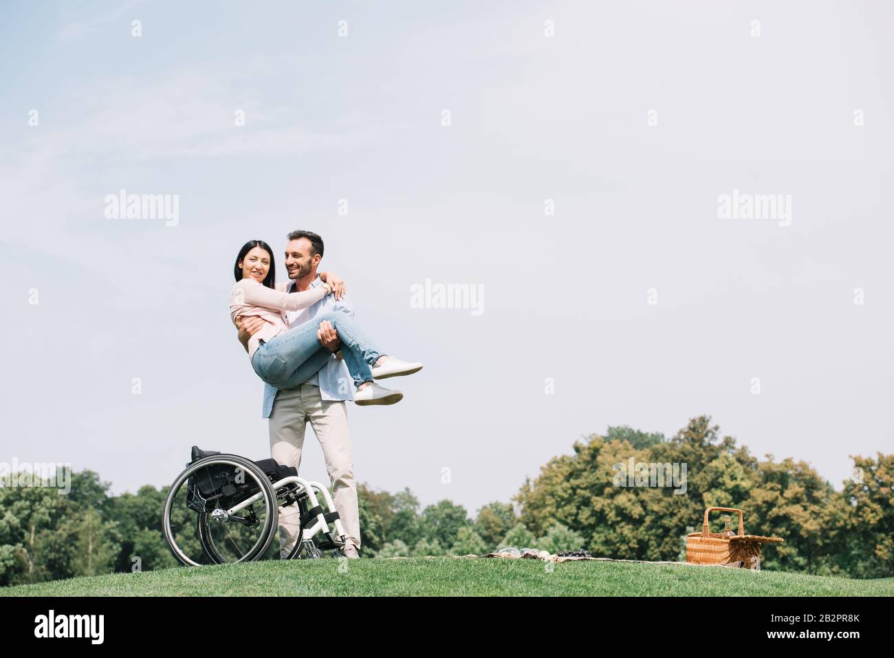 cheerful young man holding on hands happy disabled girlfriend Stock ...