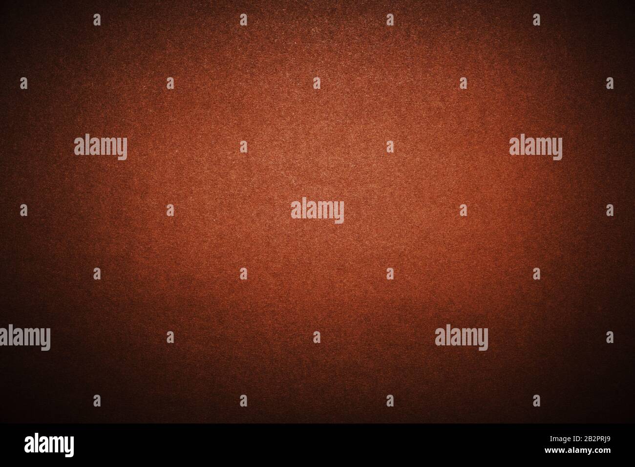 Bright brown background with vignetting. The texture of the cardboard ...