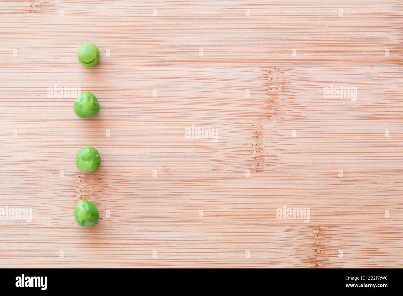 four peas representing the 4 p's of marketing presented on a wooden ...
