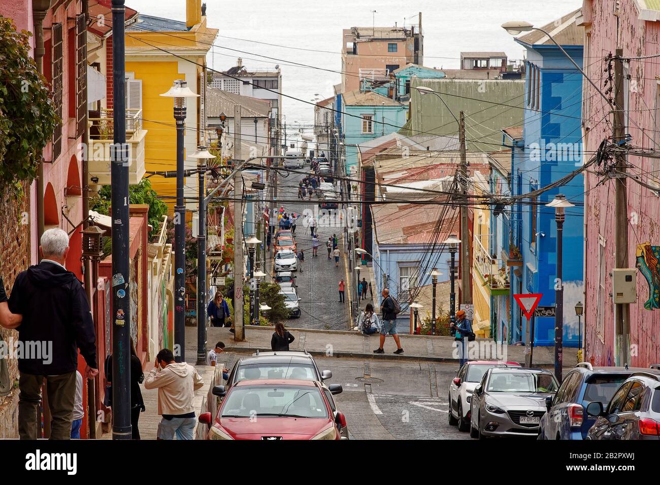 street scene, steep, colorful old buildings, people, cars, electrical ...