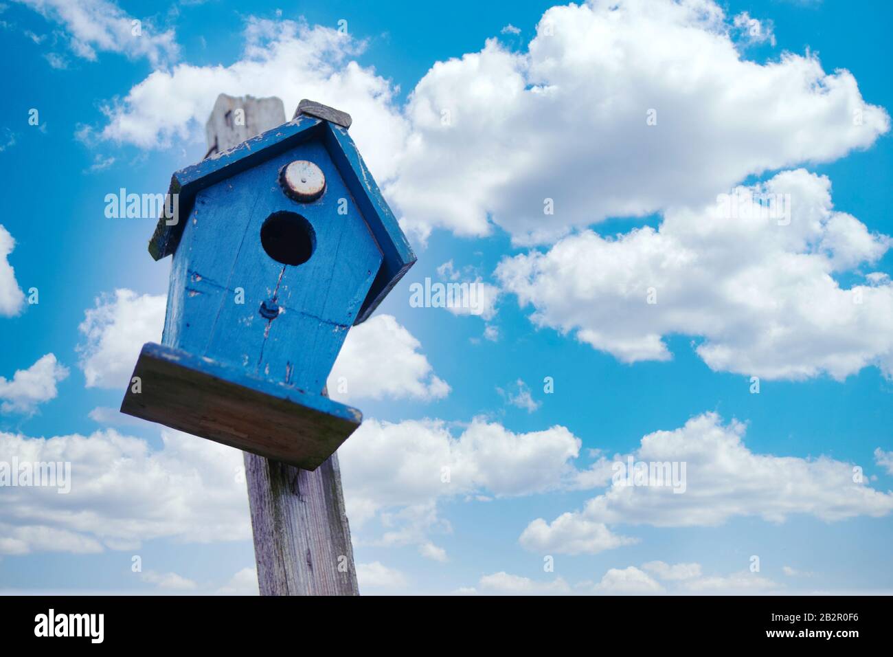 blue bird house in front of blue cloudy sky Stock Photo - Alamy
