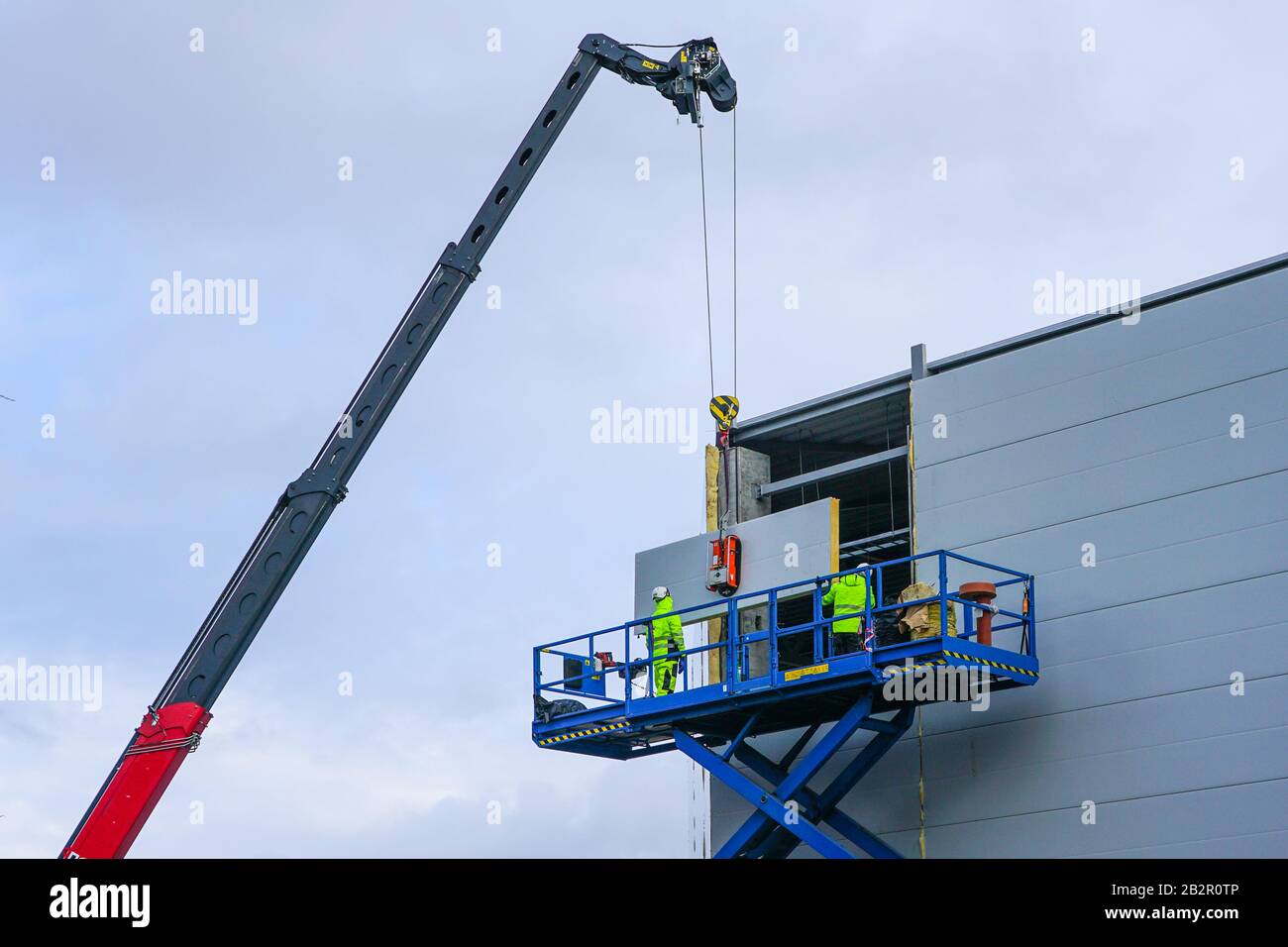 sandwich panels wall mounting using crane and scissor lift Stock Photo ...