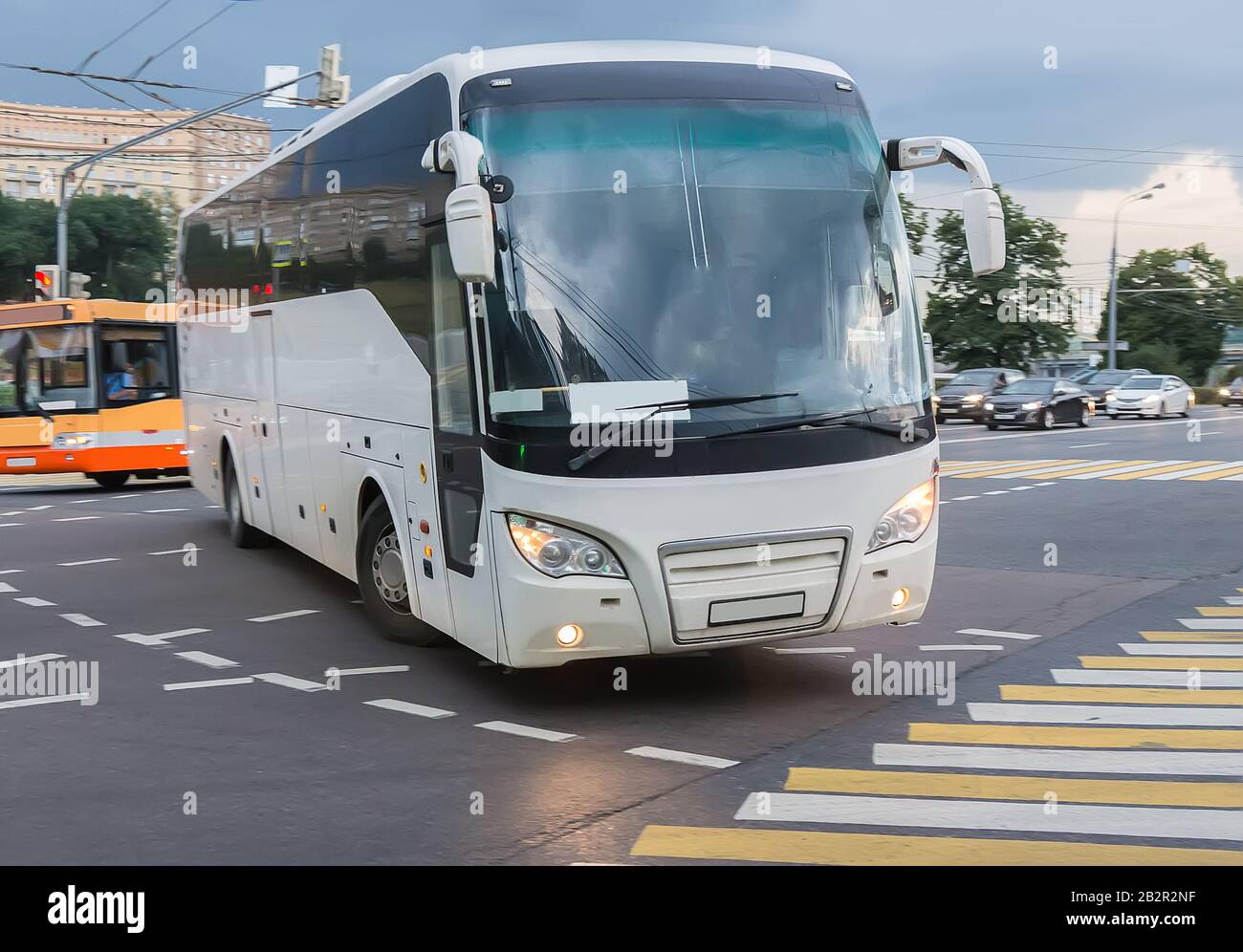 tourist bus at the city intersection Stock Photo - Alamy