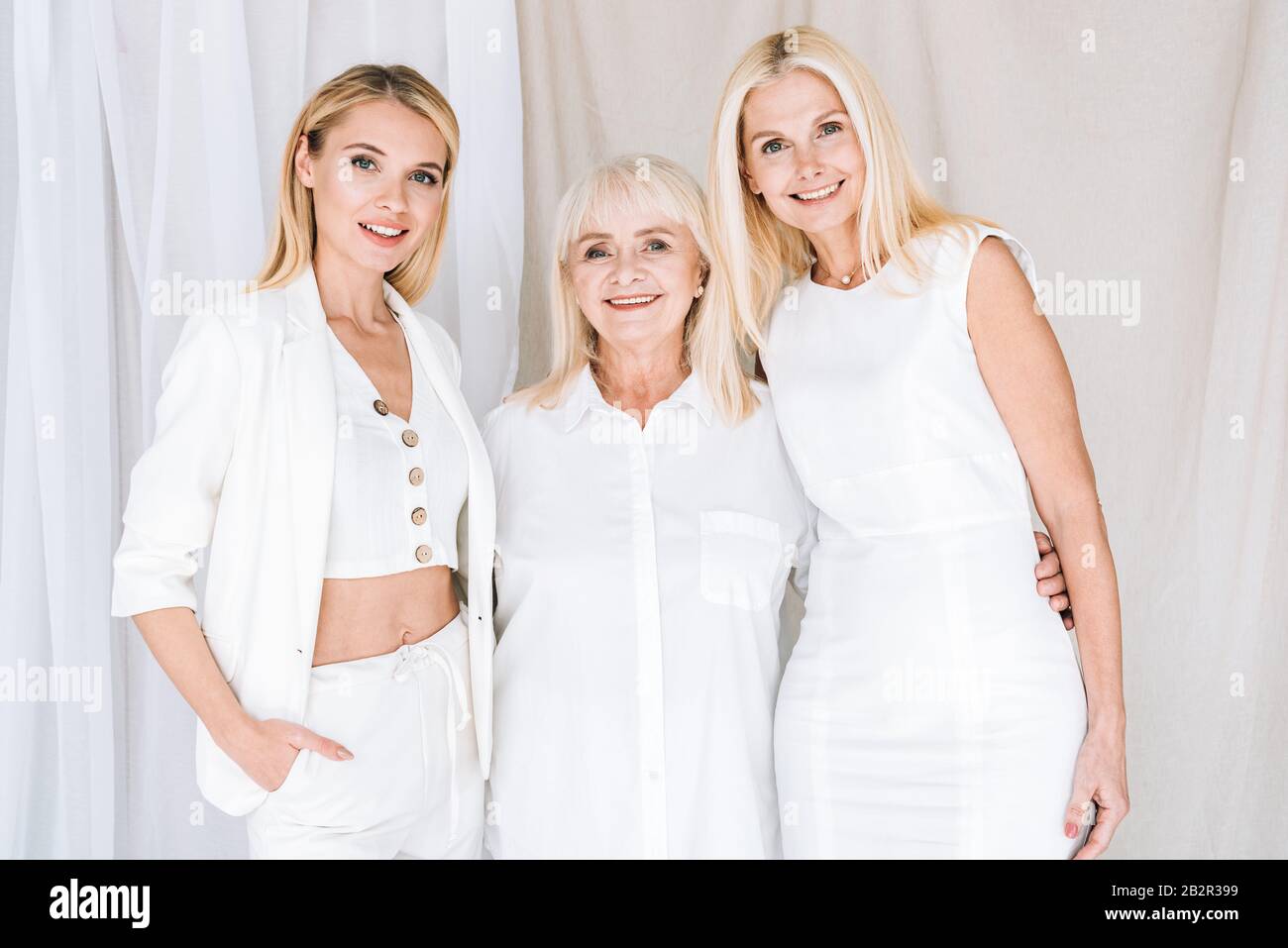 elegant three generation blonde women in total white outfits Stock ...