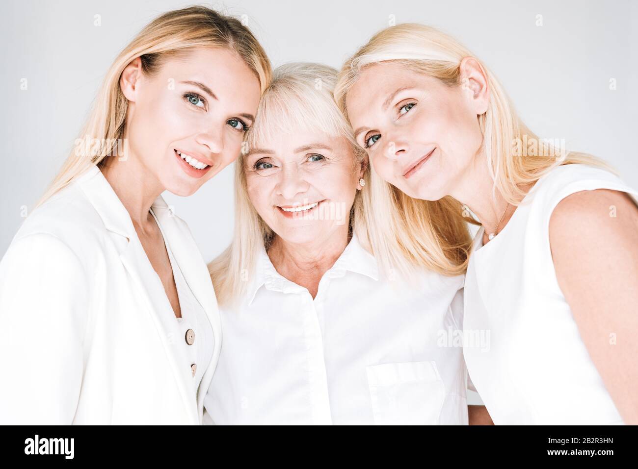 three generation blonde beautiful women isolated on grey Stock Photo ...