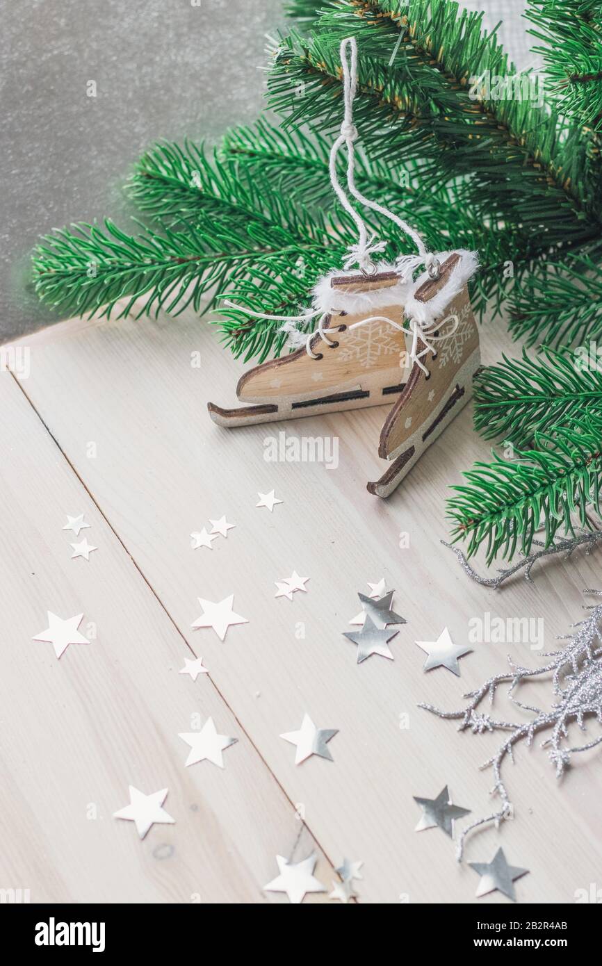 Vertical picture of little wooden toy skates surrounded by decorations ...