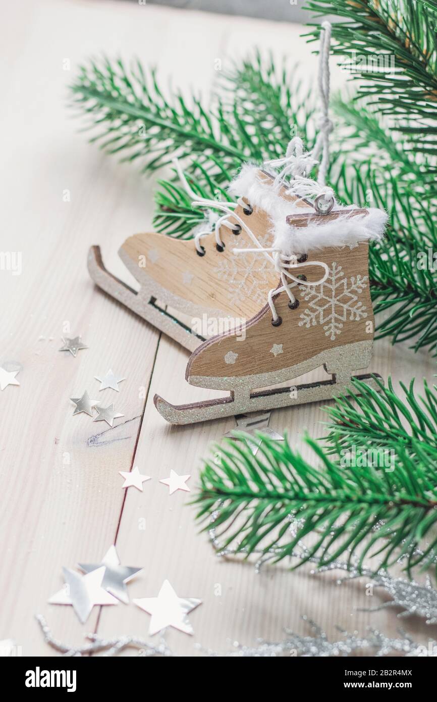Vertical picture of little wooden toy skates surrounded by decorations ...
