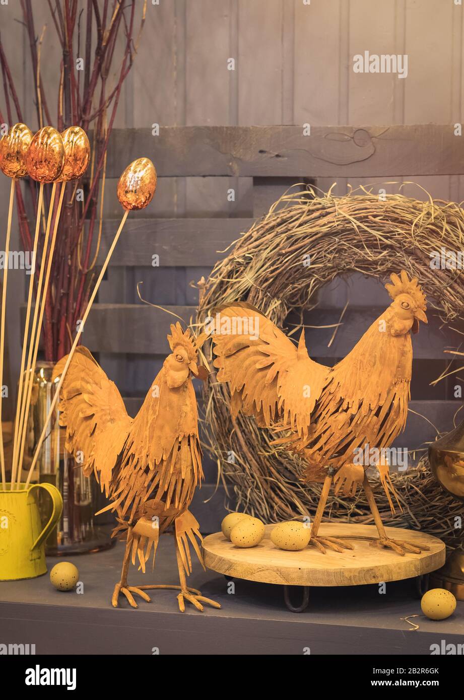 Easter composition background with decorative ochre colored metall hens ...