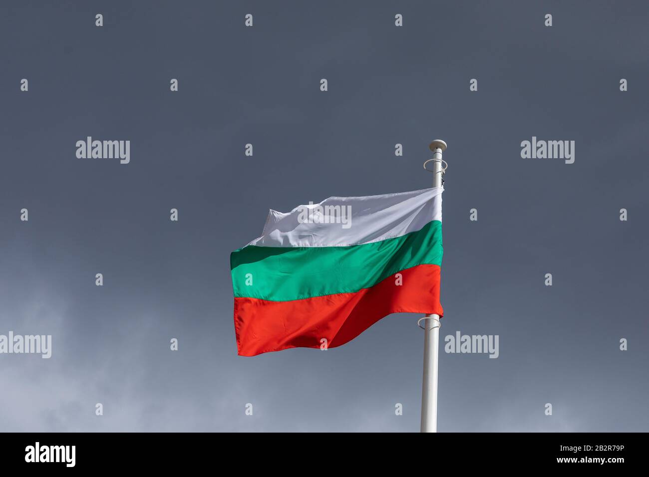 Waving Bulgarian flag on blue sky background Stock Photo - Alamy
