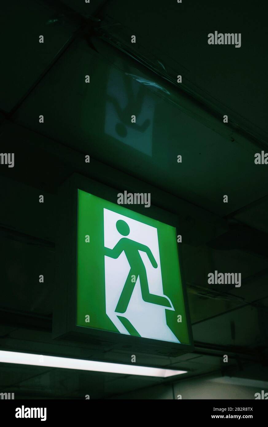 Green sign of the emergency entrance in the subway station in Japan ...