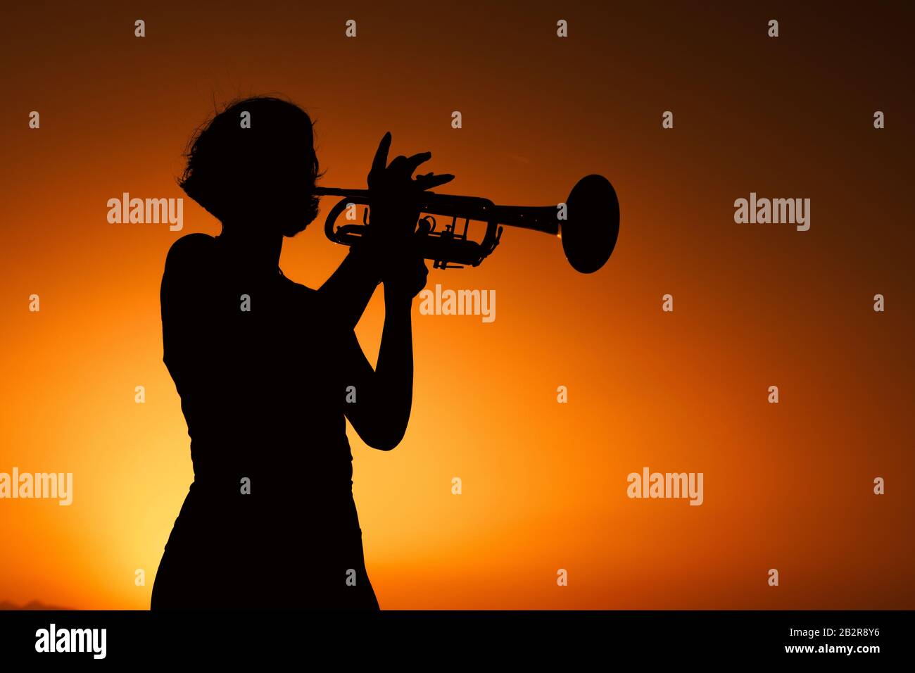 Woman playing trumpet hi-res stock photography and images - Alamy