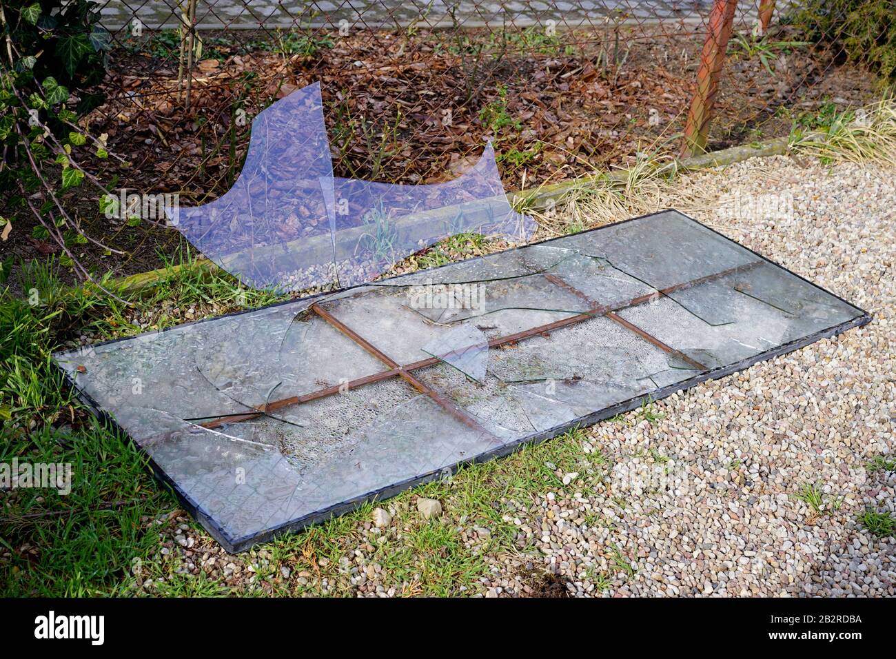 a broken, old window in the yard is waiting for waste disposal and ...
