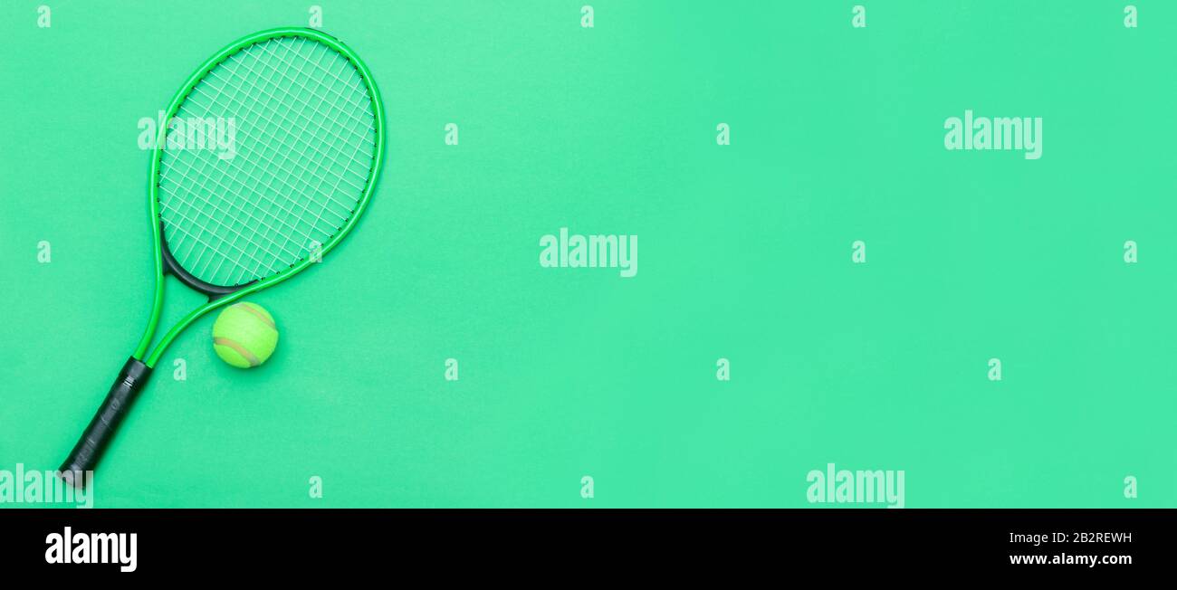 Top view of tennis racket and ball of green background. Horizontal ...