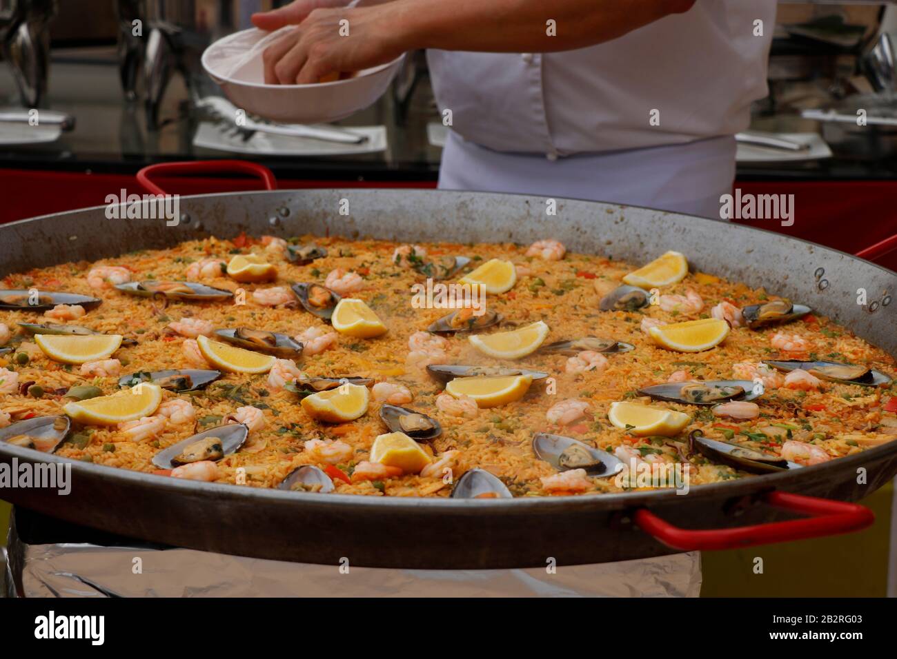 chef cooking Spanish paella in outdoor area Stock Photo - Alamy